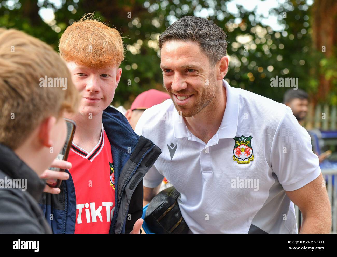 Wrexham's Ben Tozer poses for pictures with fans as he arrives for the ...