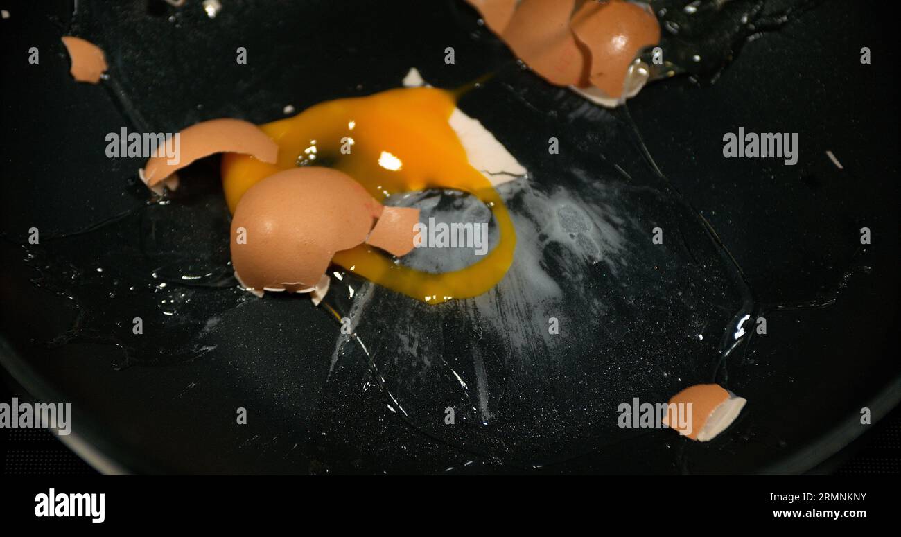 Egg bursting into a stove Stock Photo - Alamy