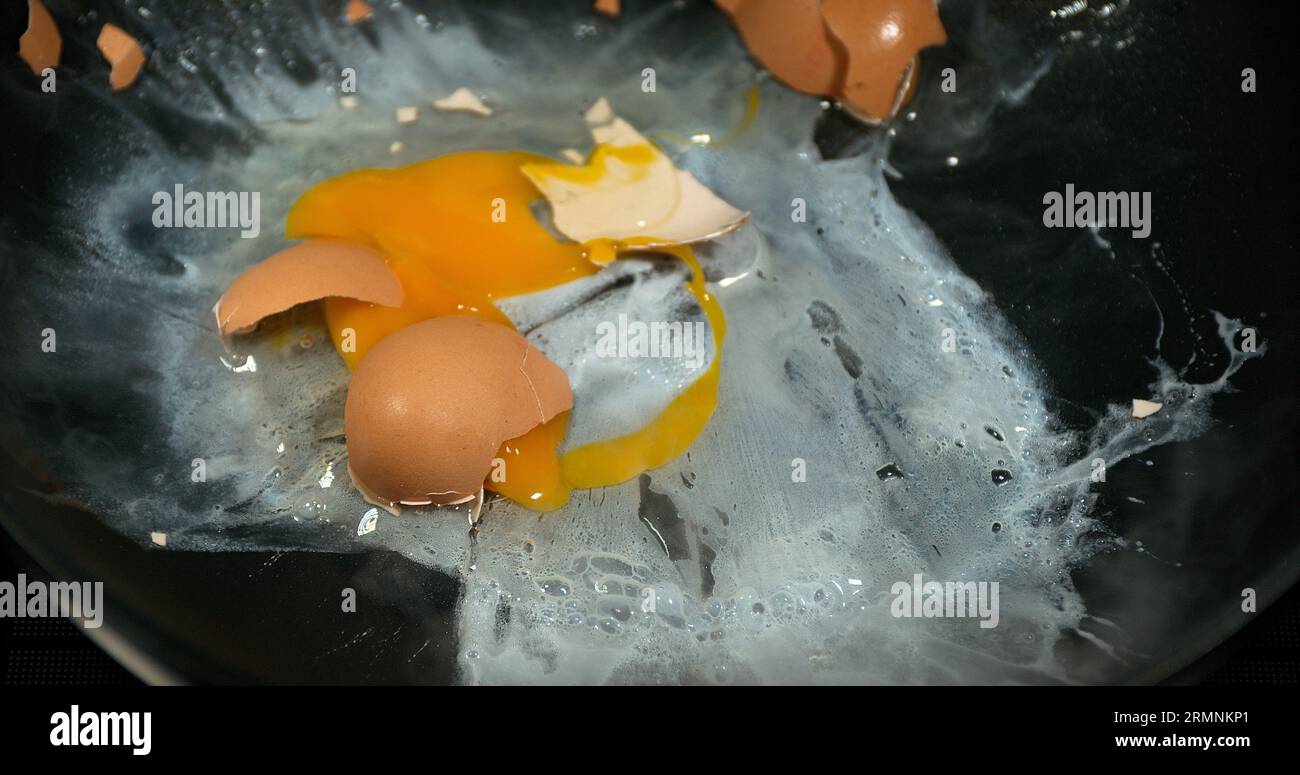 Egg bursting into a stove Stock Photo - Alamy