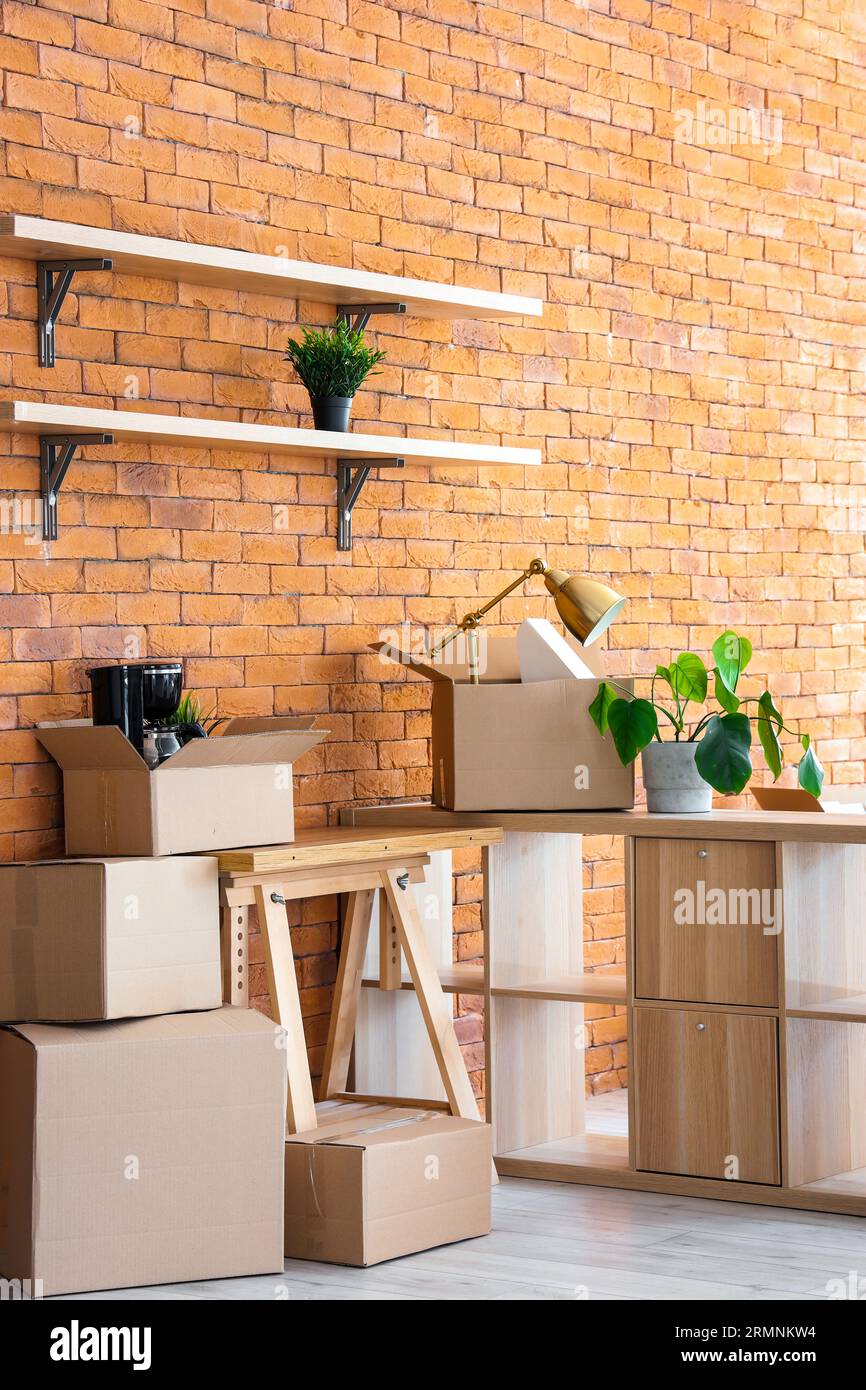Interior of stylish office with cardboard boxes on moving day Stock ...