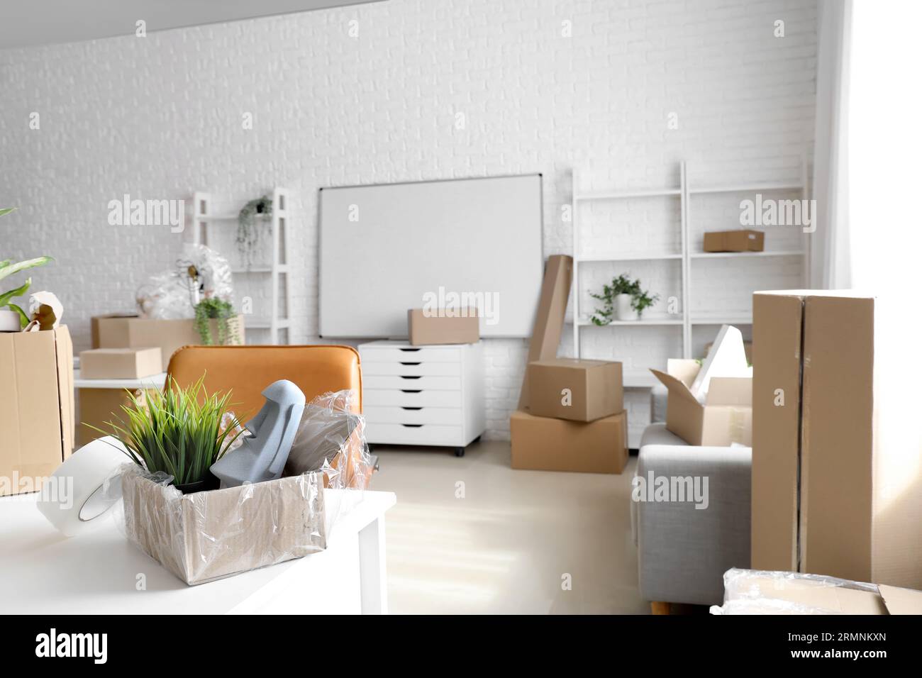 Modern workplace with cardboard boxes in office on moving day Stock ...