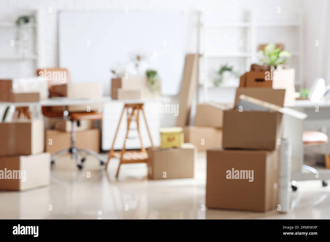 Blurred view of office with cardboard boxes on moving day Stock Photo ...