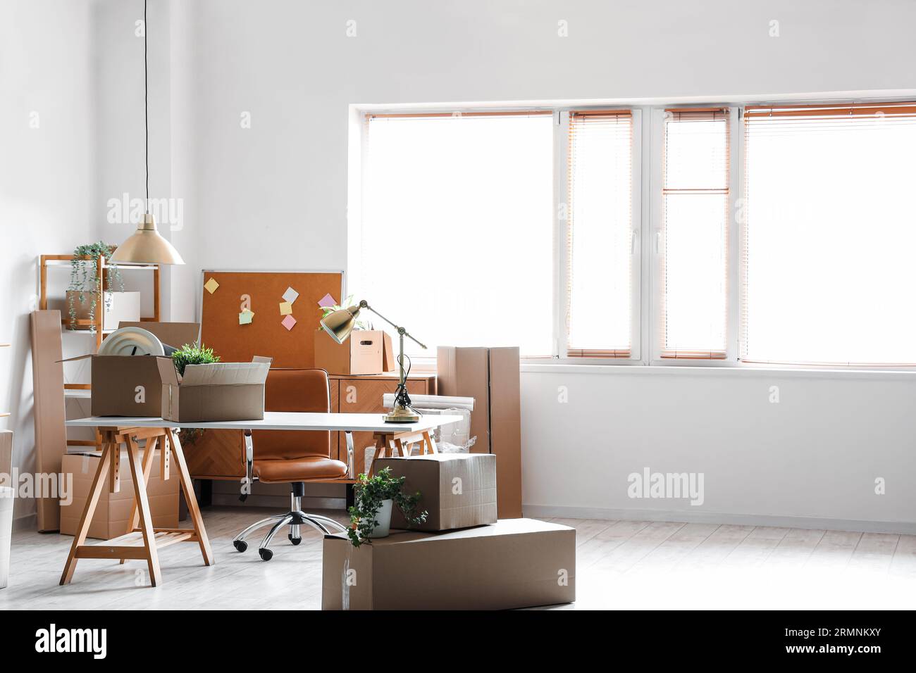 Modern workplace with cardboard boxes in office on moving day Stock ...