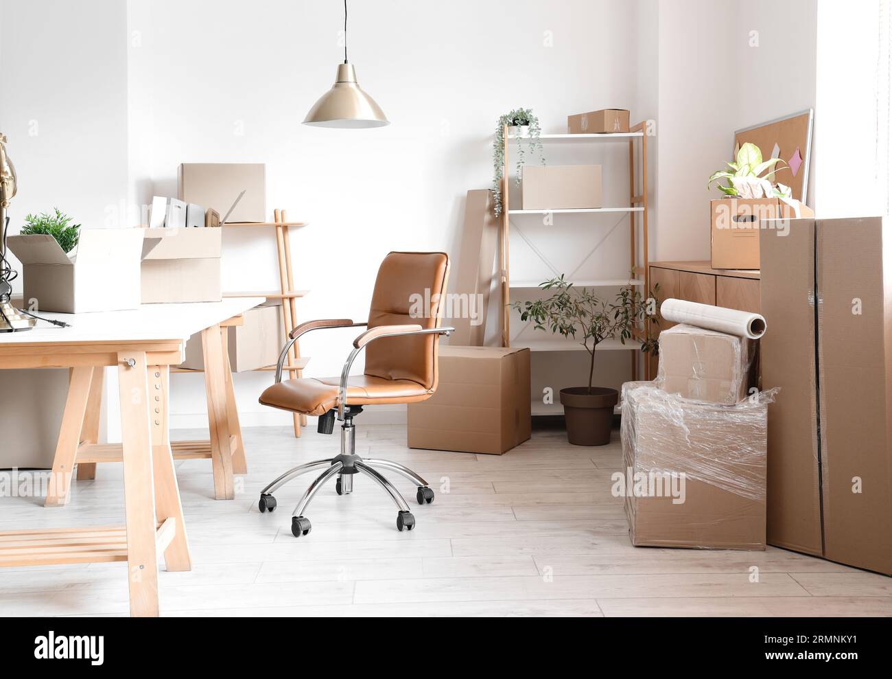 Modern workplace with cardboard boxes in office on moving day Stock ...