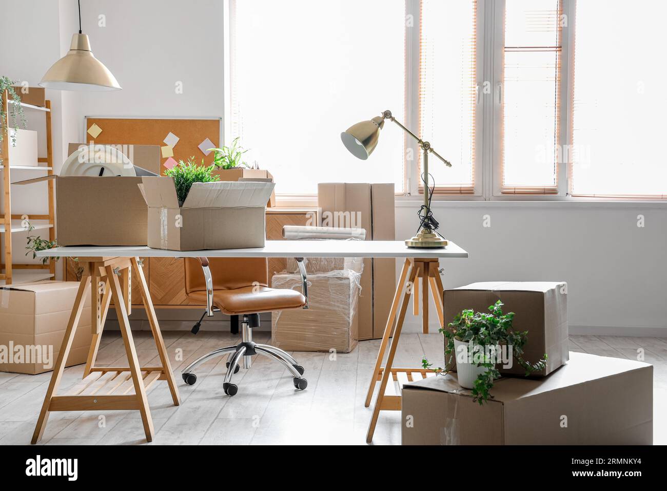 Modern workplace with cardboard boxes in office on moving day Stock ...