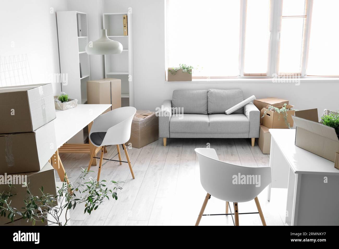 Modern workplaces with cardboard boxes in office on moving day Stock ...