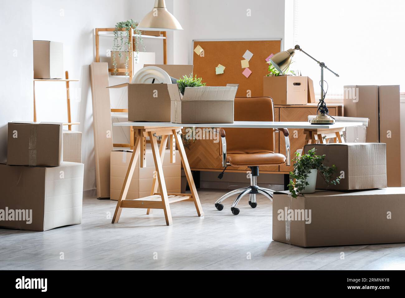 Modern workplace with cardboard boxes in office on moving day Stock ...