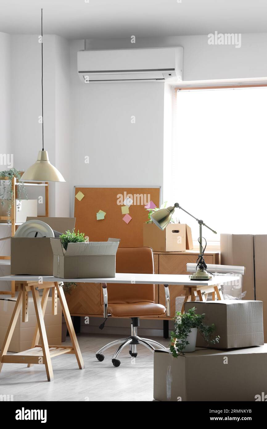 Modern workplace with cardboard boxes in office on moving day Stock ...