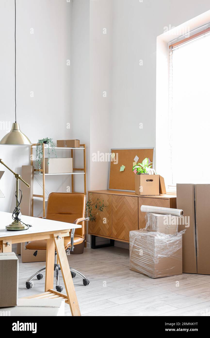 Modern workplace with cardboard boxes in office on moving day Stock ...