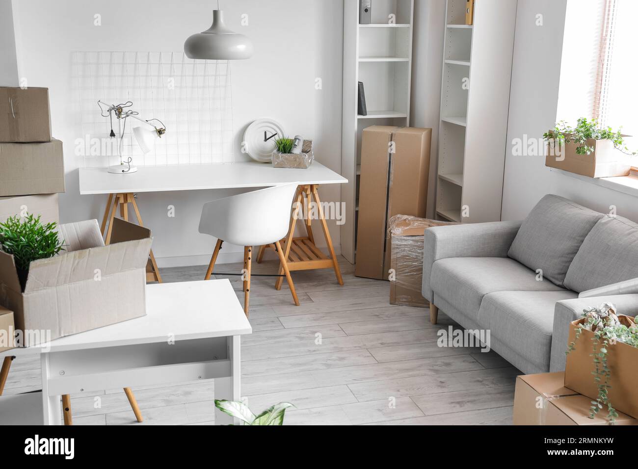 Modern workplaces with cardboard boxes in office on moving day Stock ...