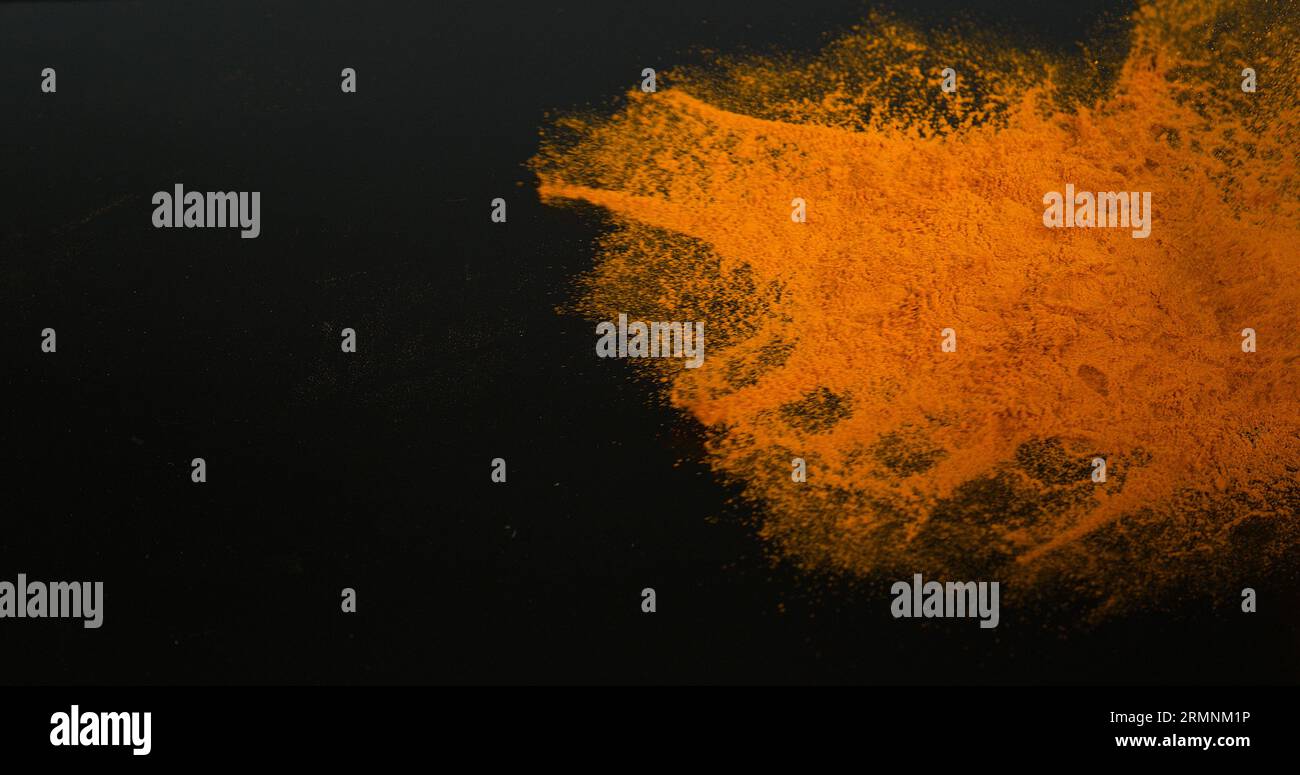 Turmeric, curcuma longa, Powder falling against Black Background ...