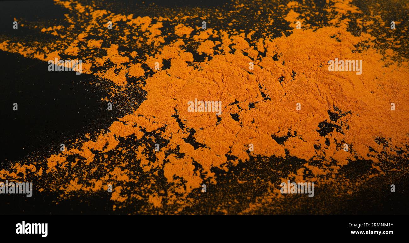 Turmeric, curcuma longa, Powder falling against Black Background ...
