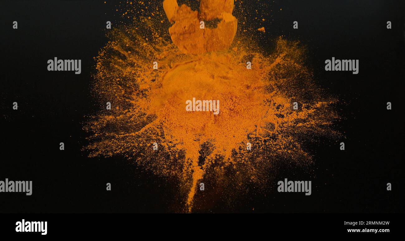 Turmeric, curcuma longa, Powder falling against Black Background ...
