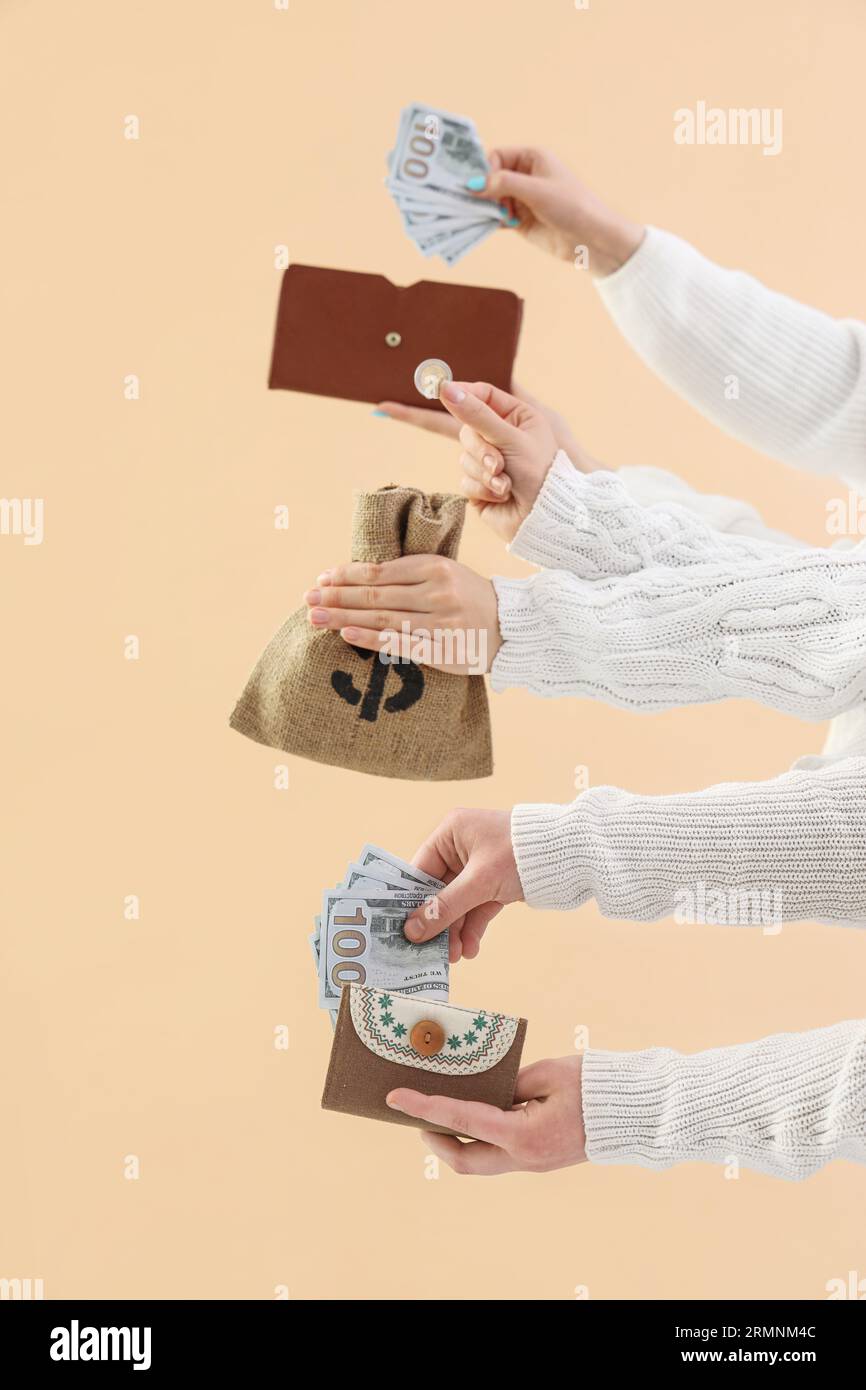 Women with money, bag and wallets on beige background Stock Photo - Alamy