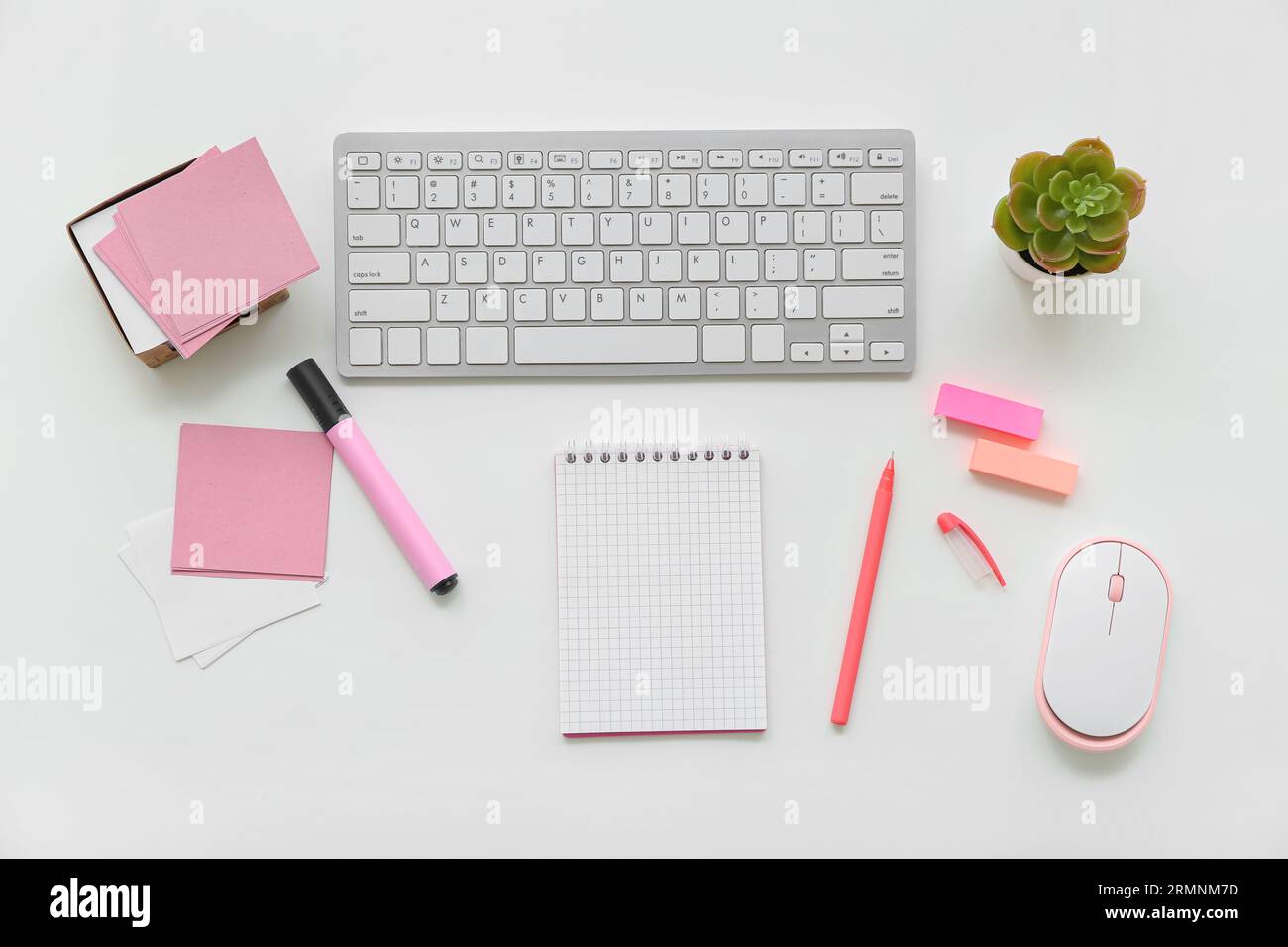 Composition with sticky notes, keyboard and notebook on white ...