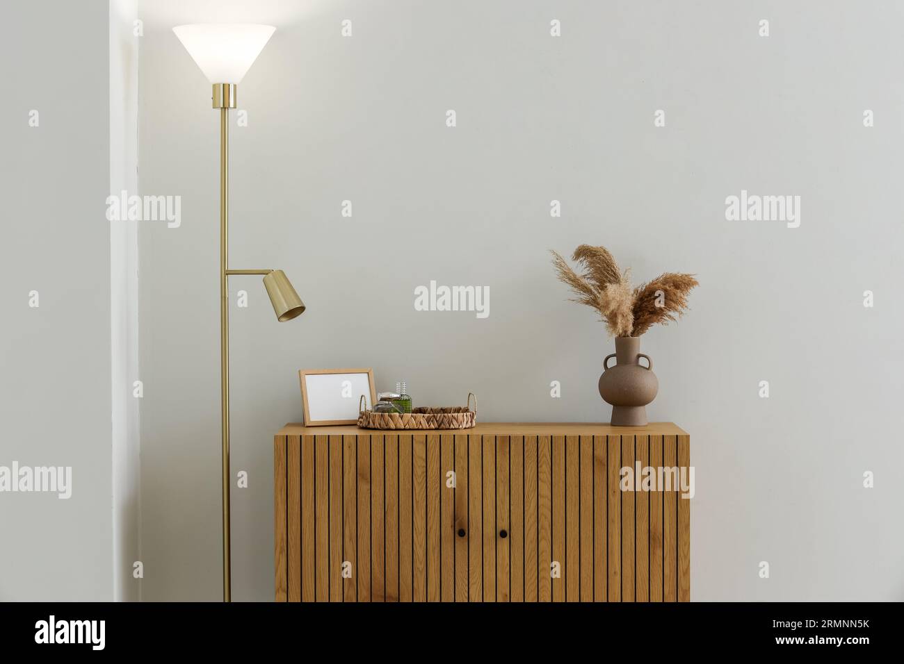 Interior of light room with glowing lamp and drawers Stock Photo - Alamy