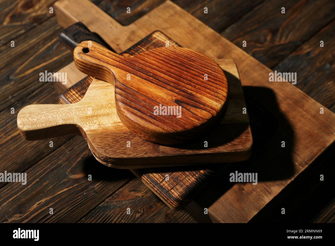 Different cutting boards on wooden background Stock Photo - Alamy