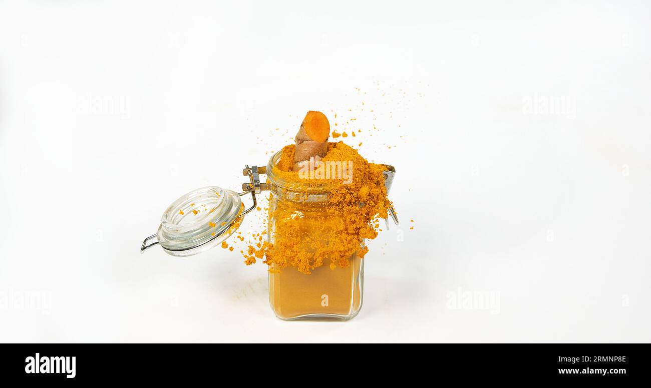 Turmeric, curcuma longa, Powder in a small Jar against White Background ...