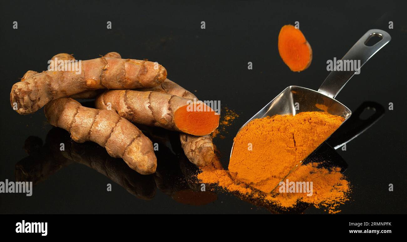 Turmeric, Turmeric Longa, Roots and Powder on Black Background, Indian ...