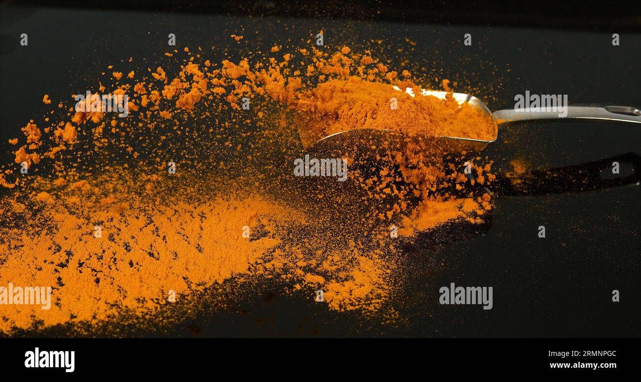 Turmeric, curcuma longa, Powder falling against Black Background ...