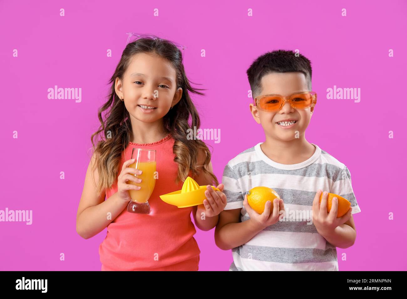 Little Asian children with fresh citrus juice, fruits and squeezer on ...