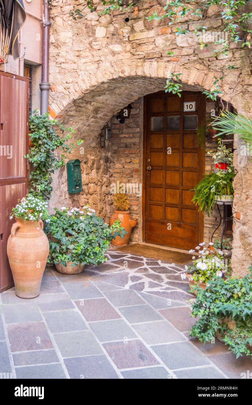 Historic house entrance in a small Italian town, hidden in a brick ...