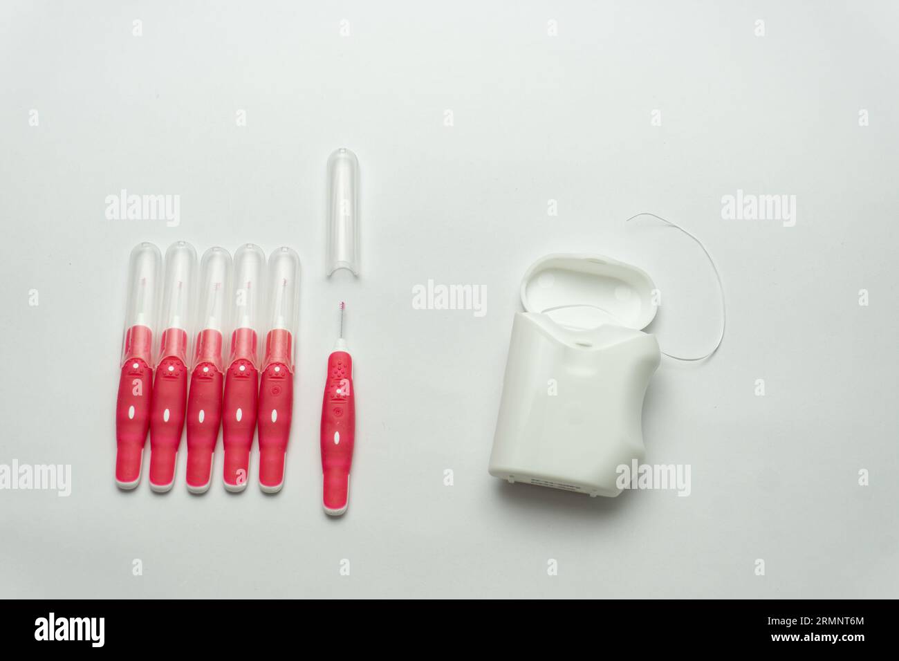 Interdental brush sticks and dental floss on white background, copy ...