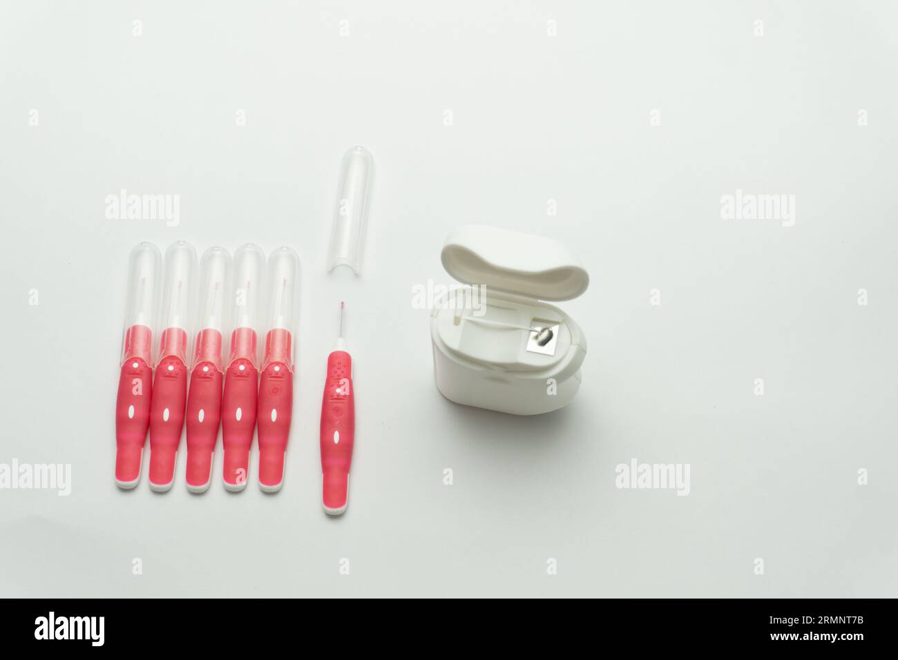 Interdental brush sticks and dental floss on white background, copy ...
