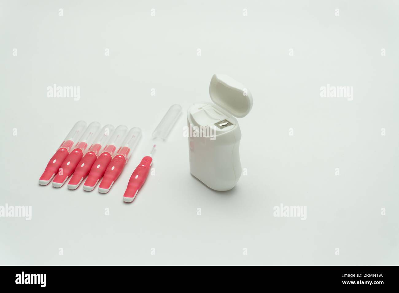 Interdental brush sticks and dental floss on white background, copy ...