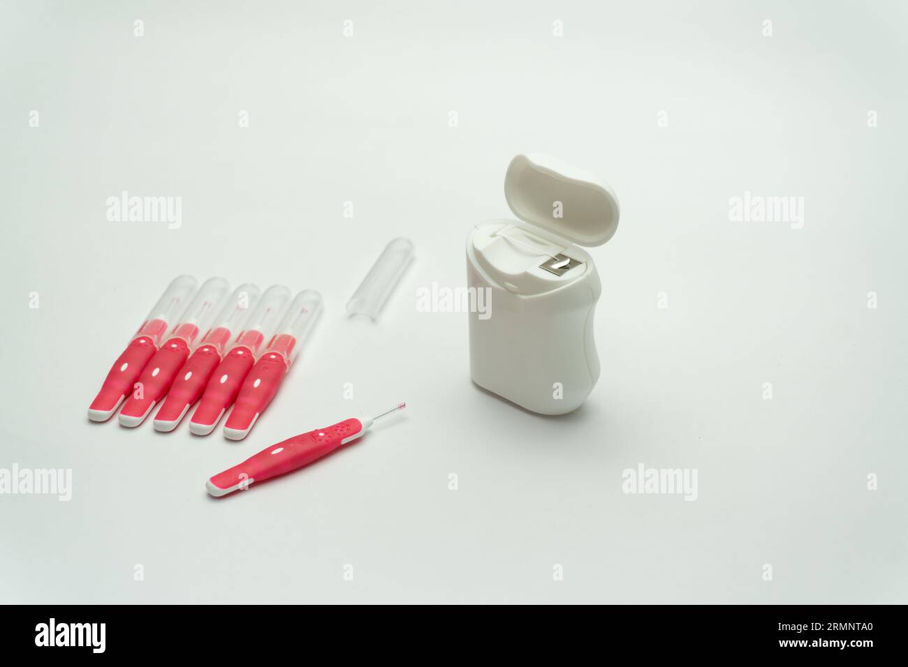 Interdental brush sticks and dental floss on white background, copy ...