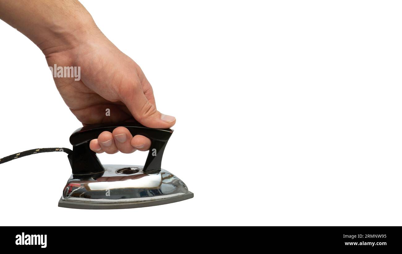 Male hand holding small old electric iron isolated on white background ...