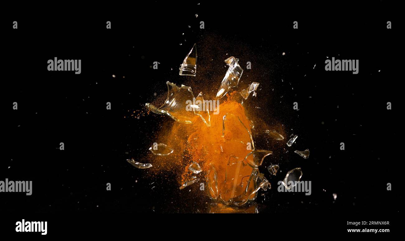 Turmeric, curcuma longa, Powder in a Small Jar Exploding against Black ...