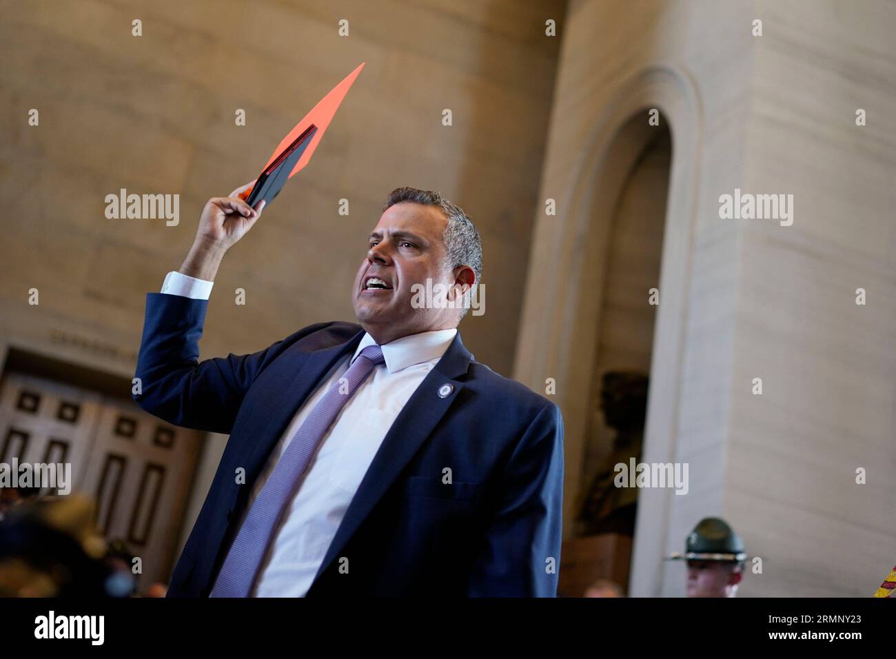 Rep. Jason Powell, D-Nashville, holds up a sign outside the House ...