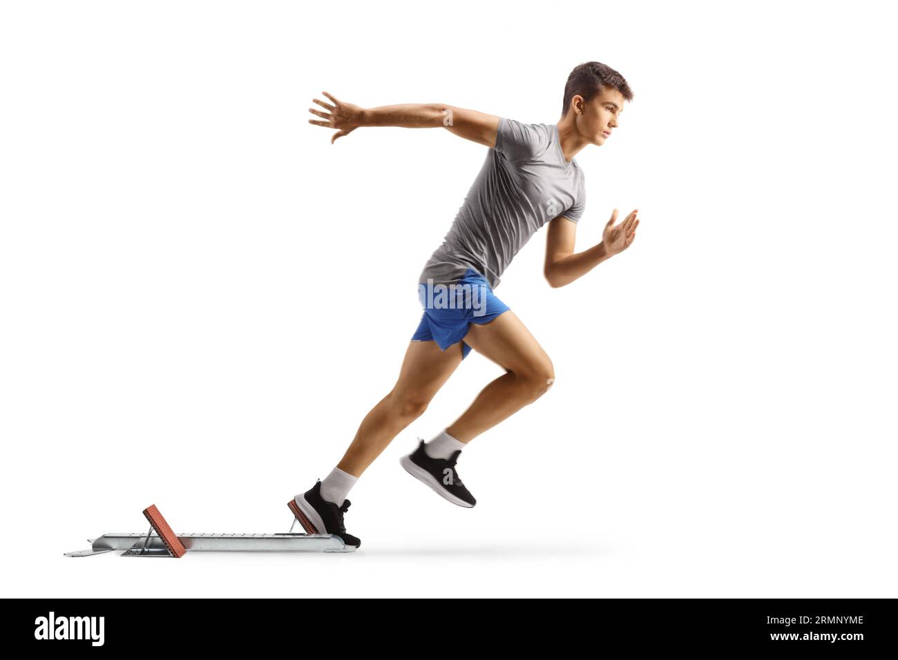 Full length profile shot of a fit young man running from start blocks ...
