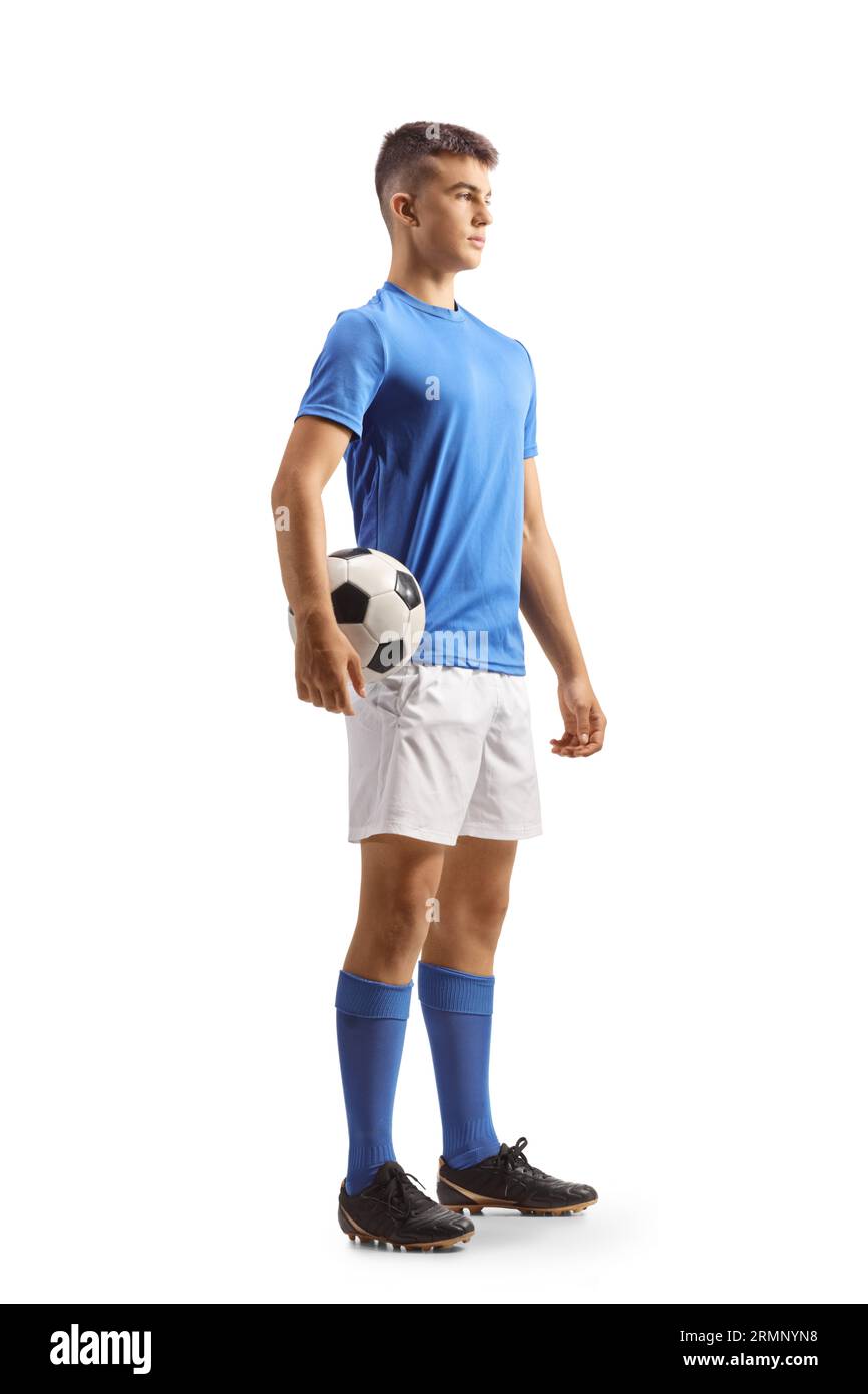 Football player in a blue top and white shorts holding a ball isolated ...