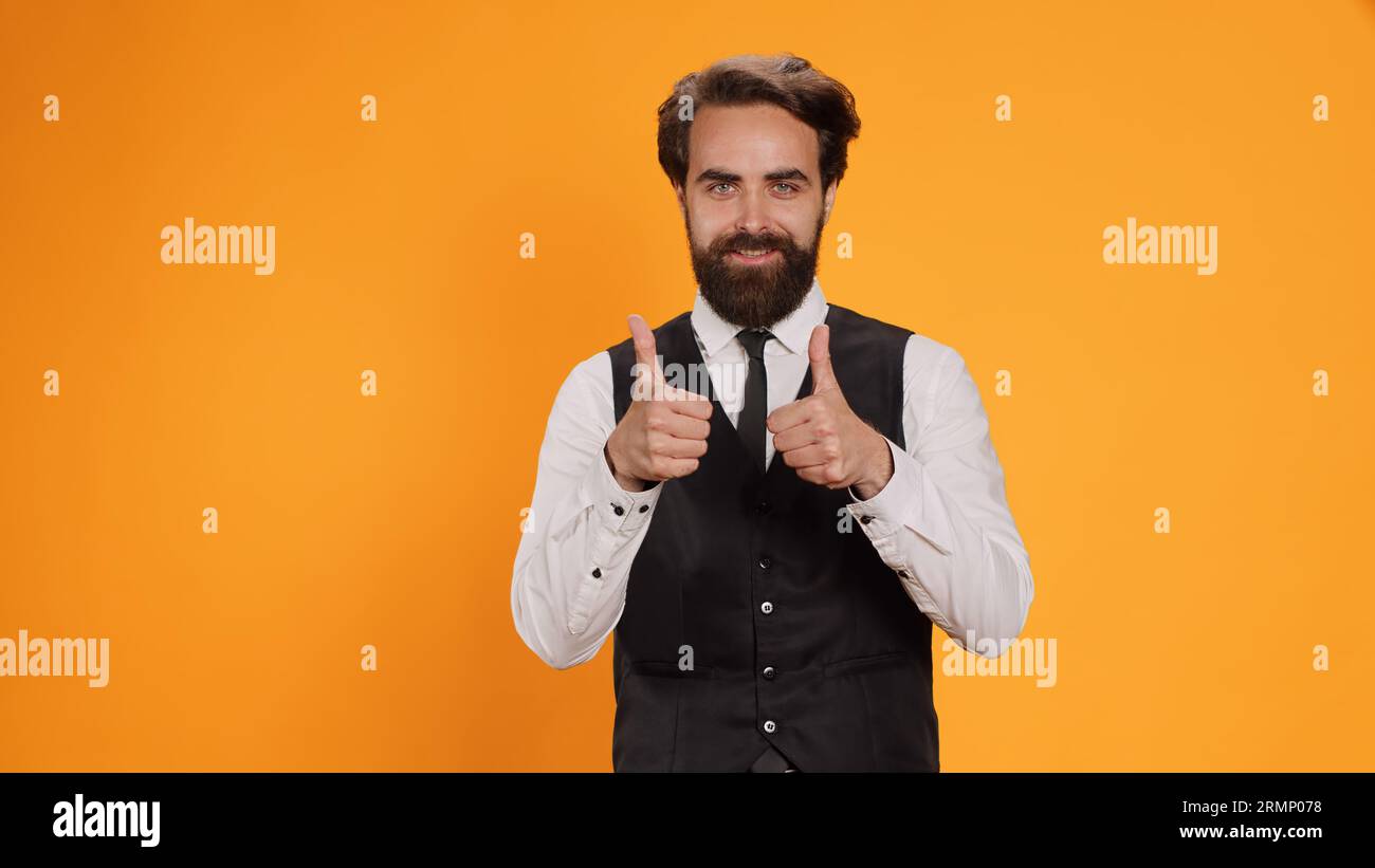 Happy server gives like symbol on camera, expressing his approval with ...