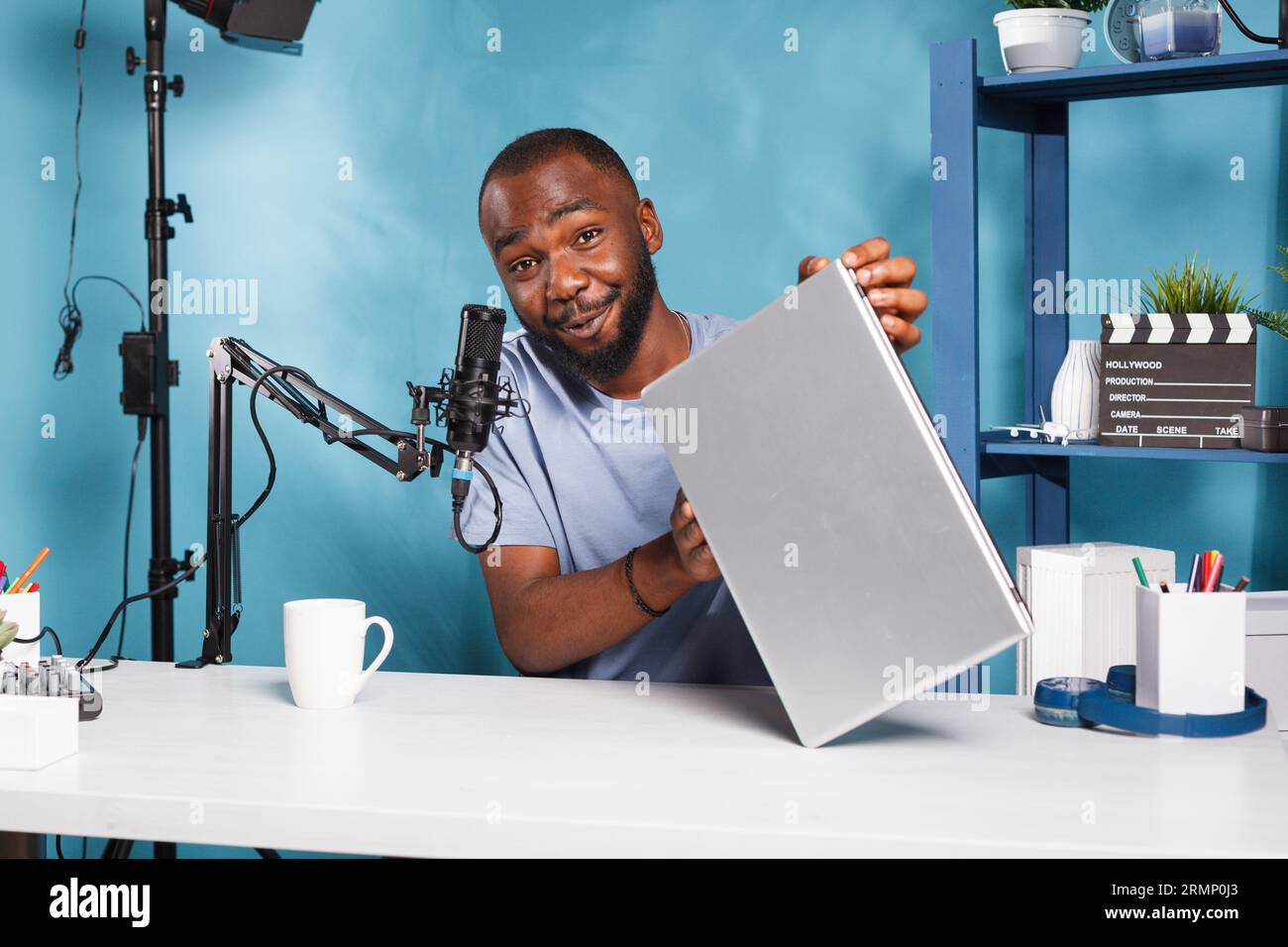 African american vlogger testing and reviewing laptop while live ...