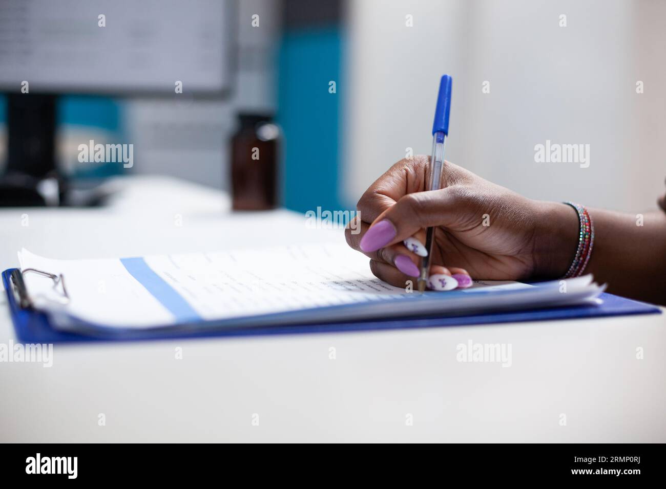 Patient signing medical application form for injury medical insurance ...