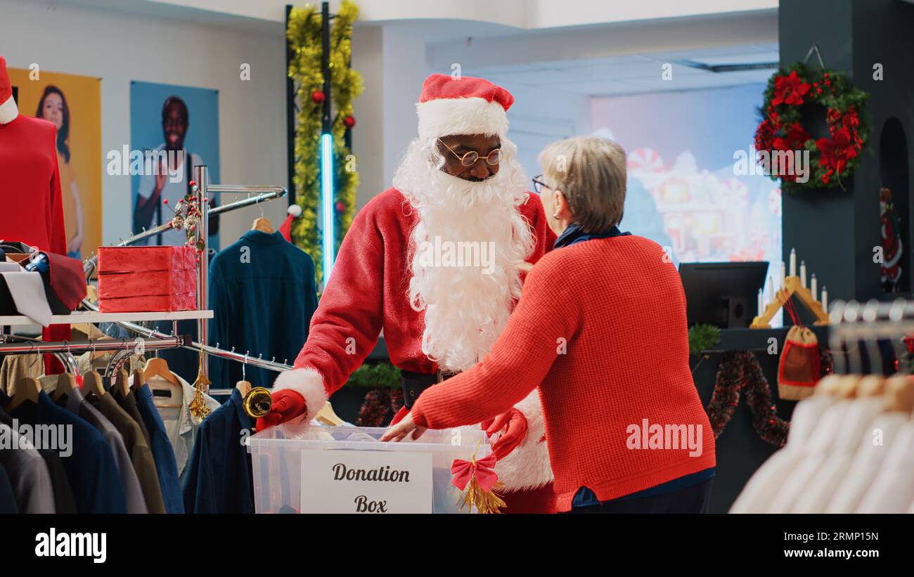 Retail assistant dressed as Santa Claus collecting unneeded clothes ...
