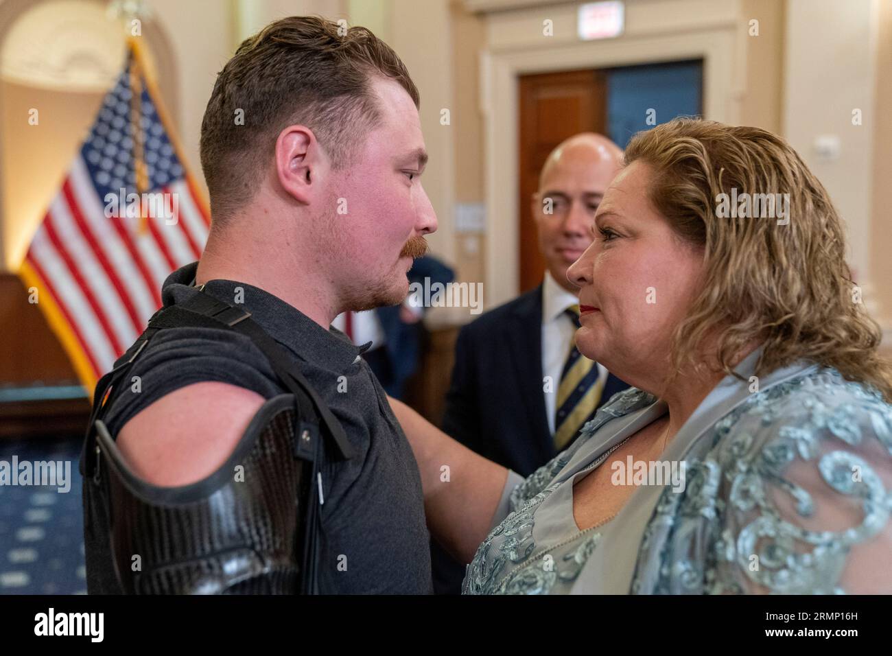 U.S. Marine Sgt. Tyler Vargas, left, Rep. Brian Mast, R-Fla., and Paula ...