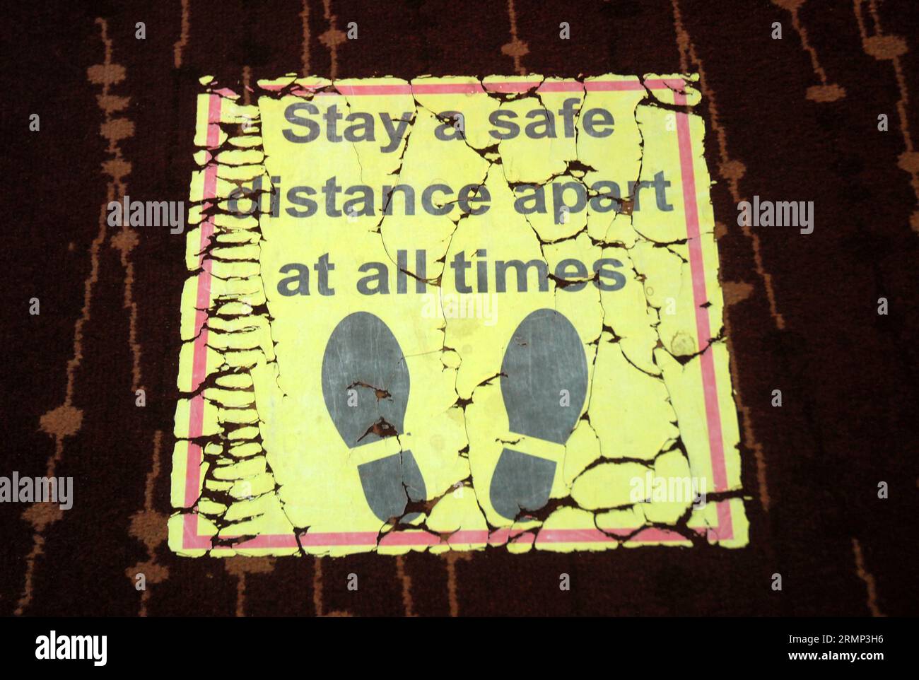 Stay a Safe Distance apart at all times ripped sign on floor of the ...