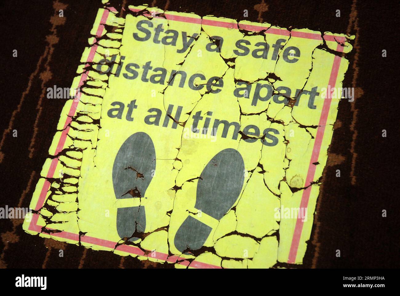 Stay a Safe Distance apart at all times ripped sign on floor of the ...