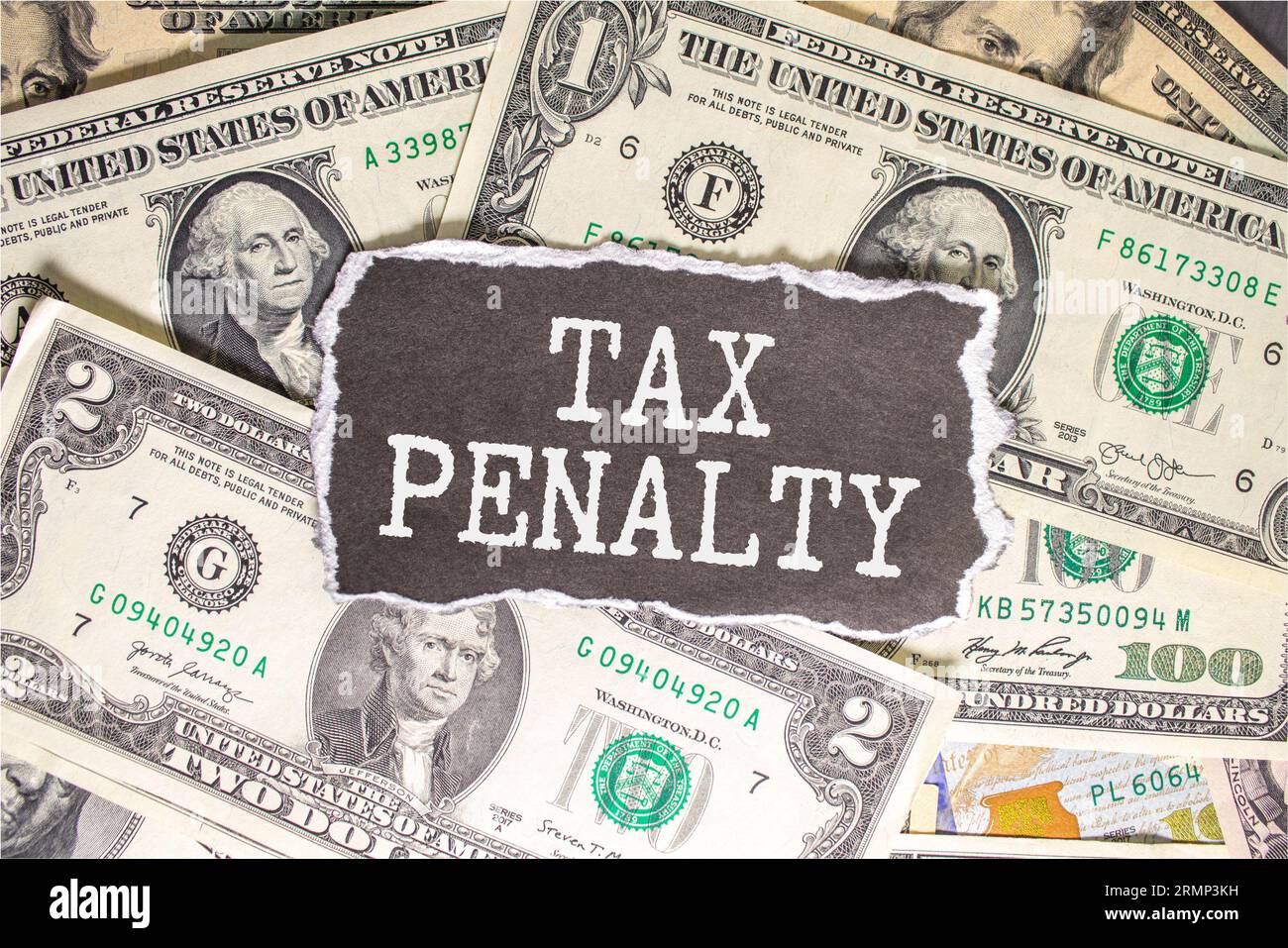 TAX PENALTY written on sticky on notebooks Stock Photo - Alamy