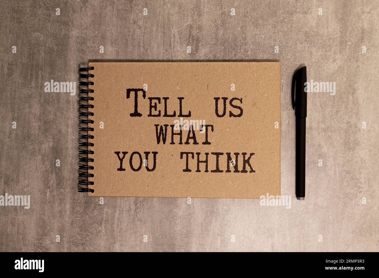 White paper with text 'tell us what you think', clip on wood clothespin ...