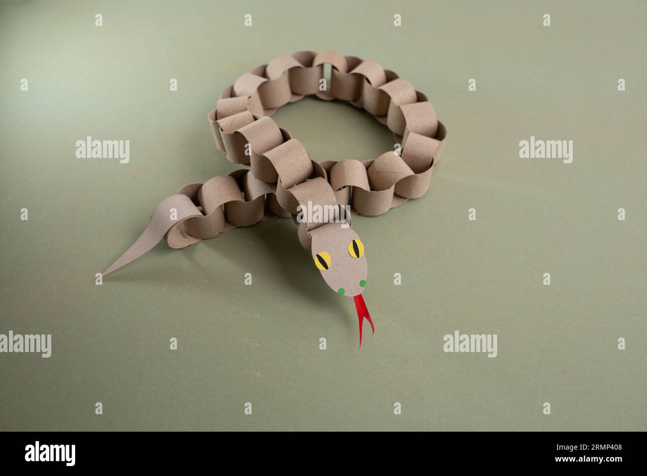 a snake made out of toilet paper rolls, craft made of recycle cardboard ...