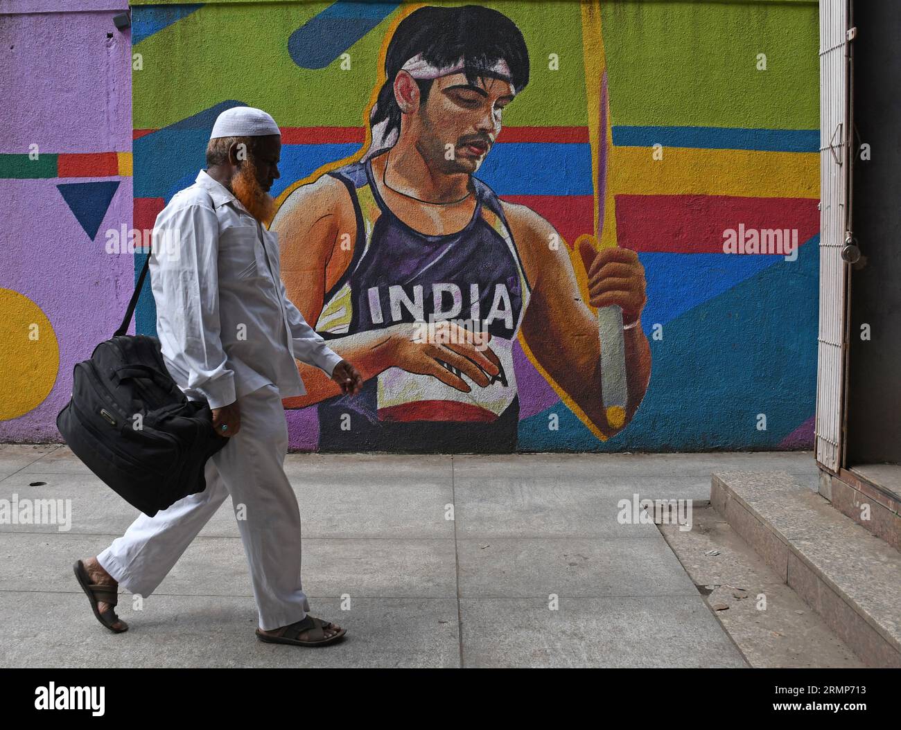 Mumbai, India. 29th Aug, 2023. A Muslim man carrying a bag walks past a ...