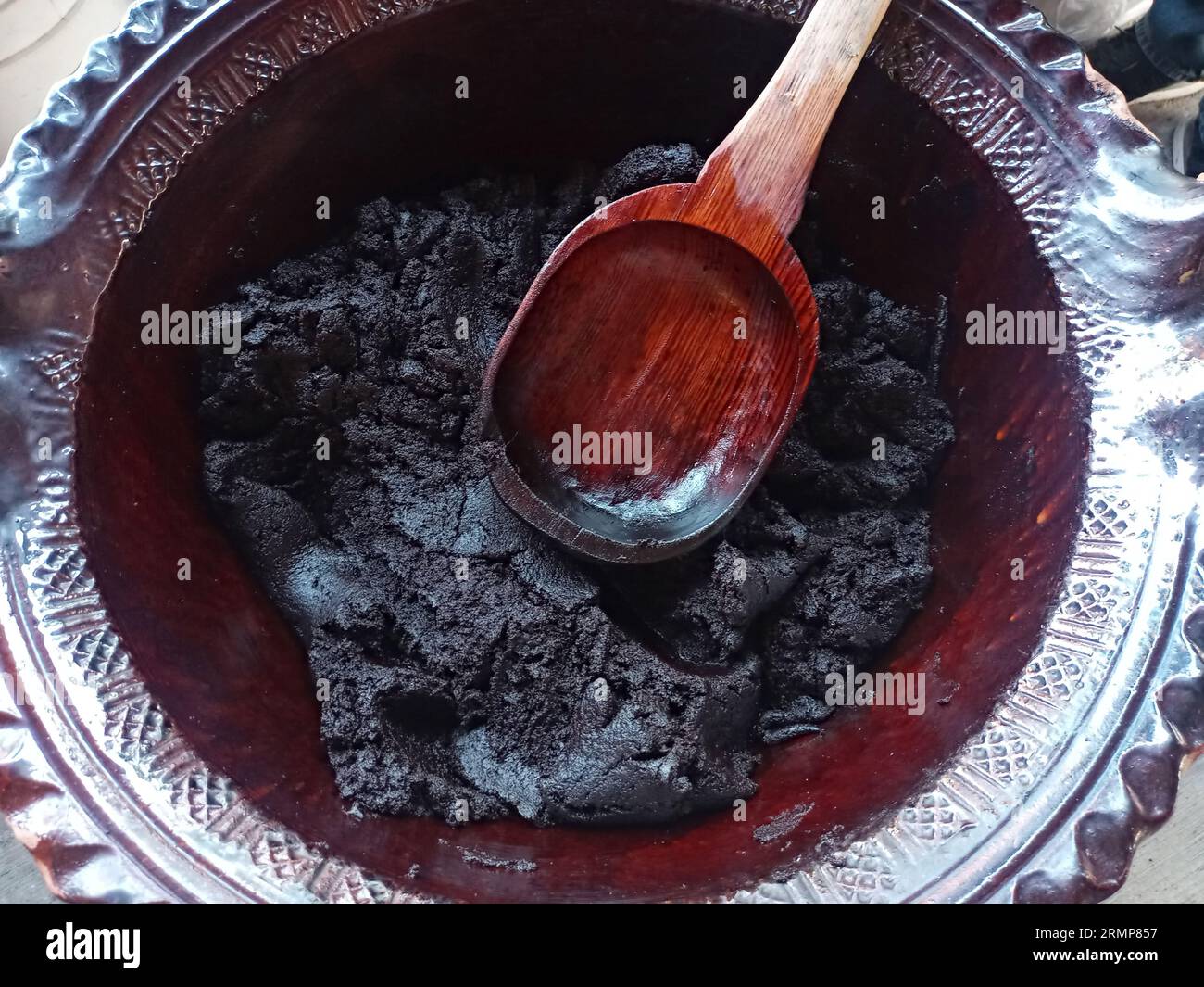 Preparation of Mexican Mole Rojo dish made with chili peppers, spices ...