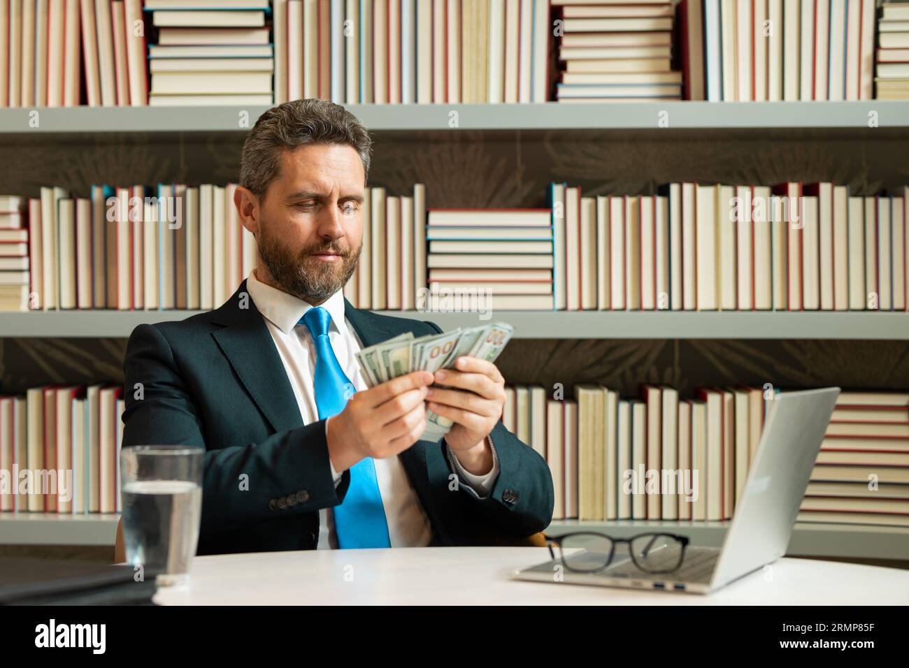 Successful business man counting money. Handsome middle age man holding ...