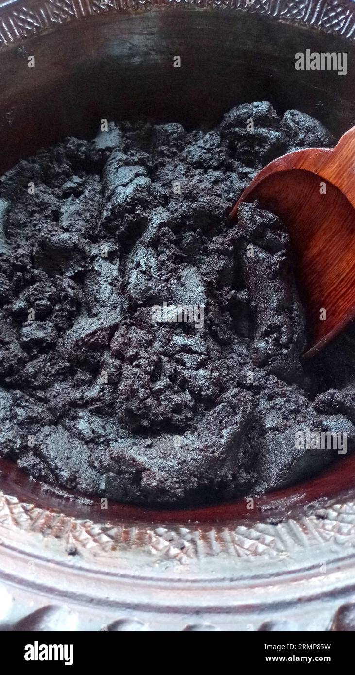 Preparation of Mexican Mole Rojo dish made with chili peppers, spices ...