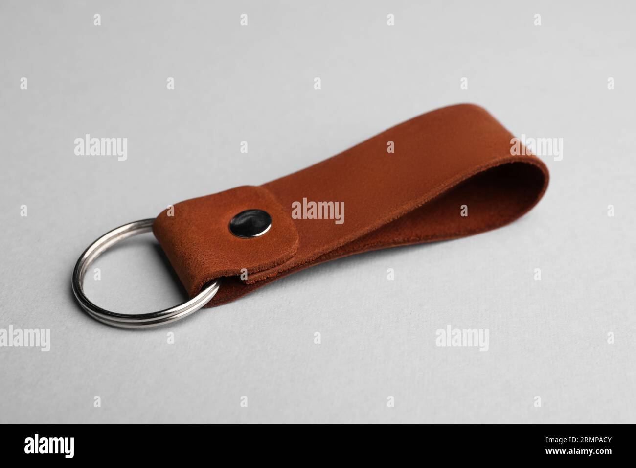 Leather keychain with Ukrainian coat of arms on light grey background ...